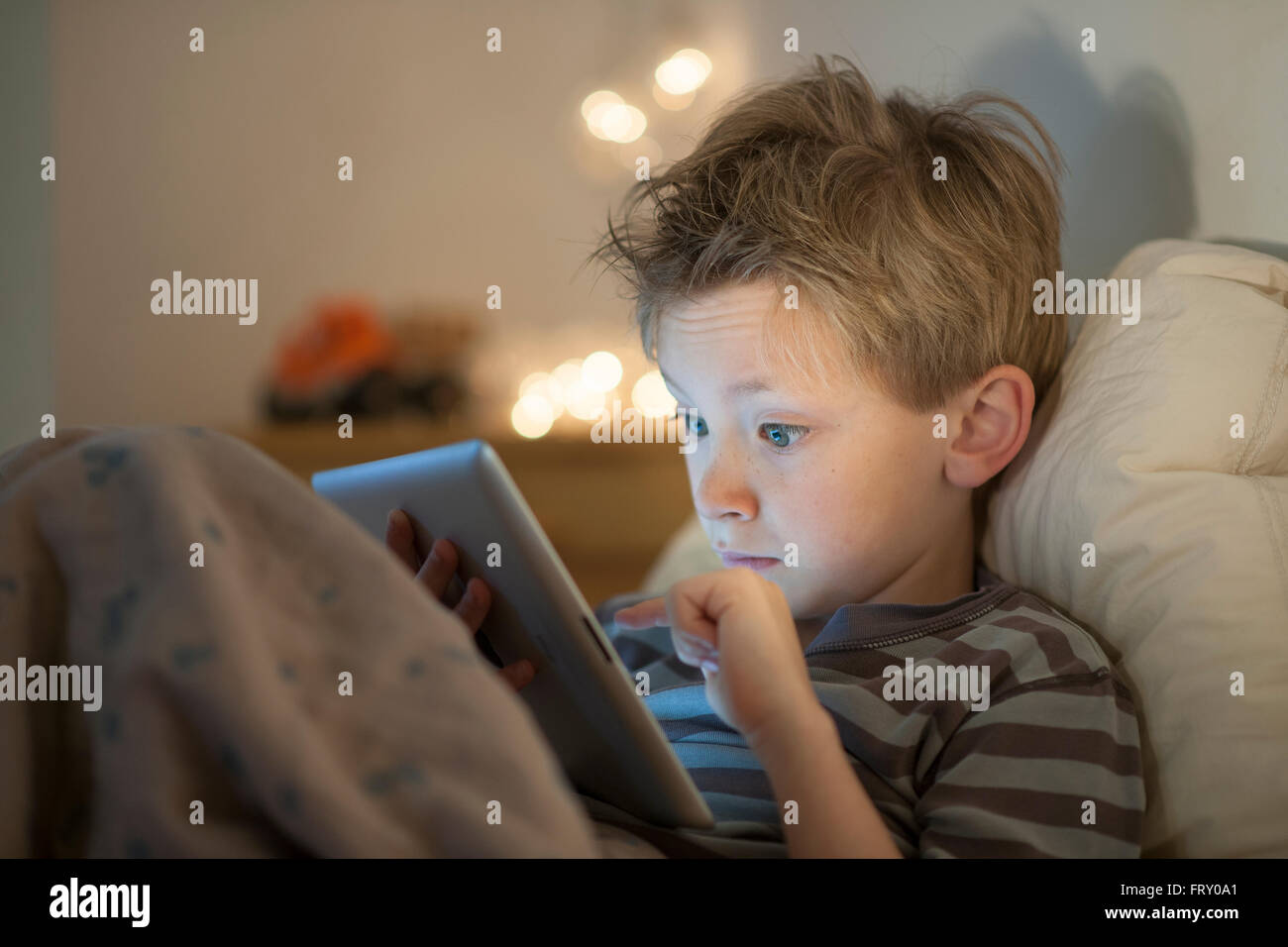 Child Using Ipad In Bed High Resolution Stock Photography and Images ...