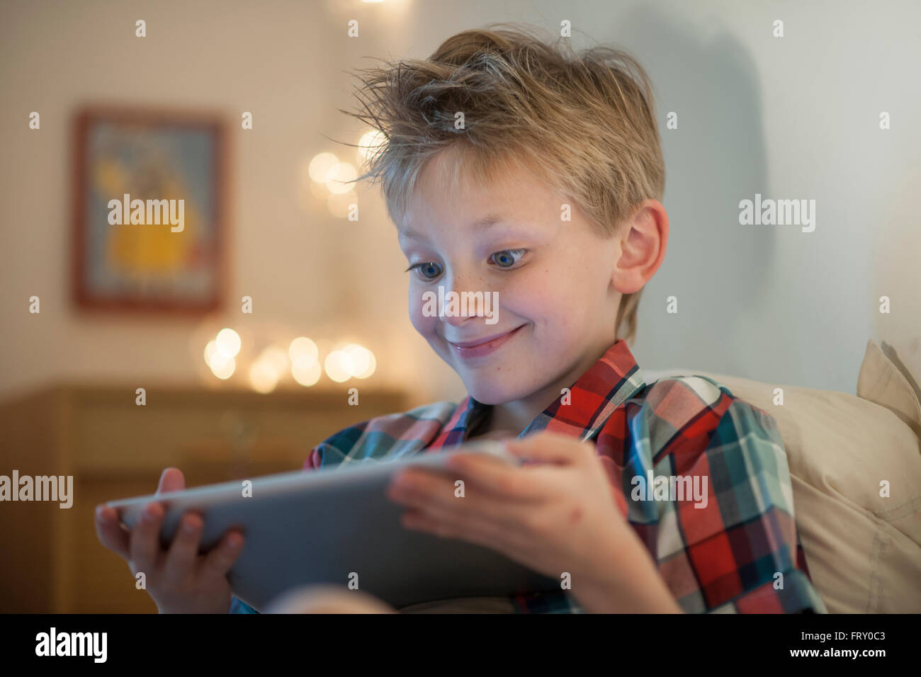 Kid using ipad in bed hi-res stock photography and images - Alamy