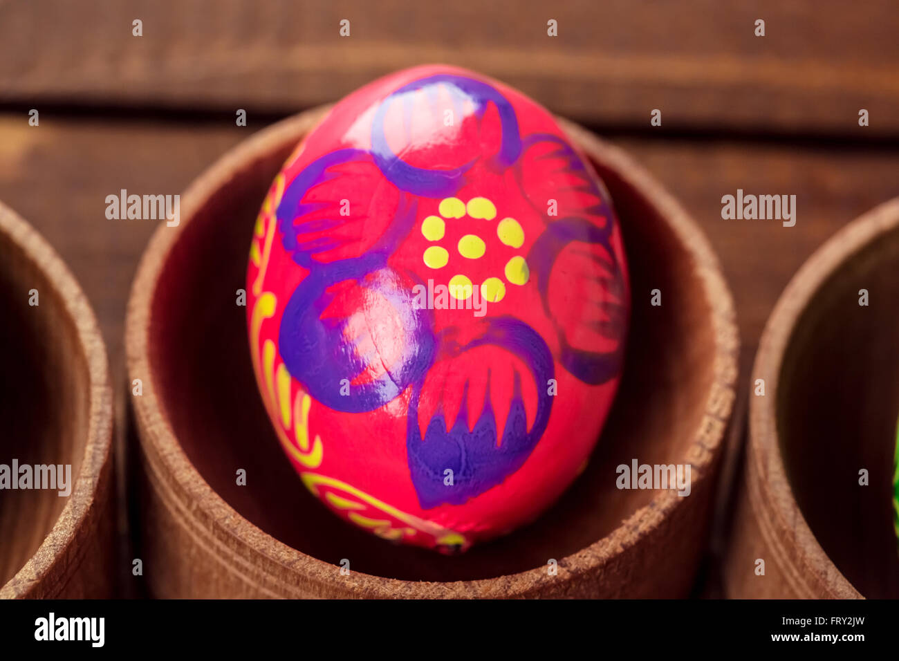 Beautiful background with painted Easter eggs in little wooden nests ...