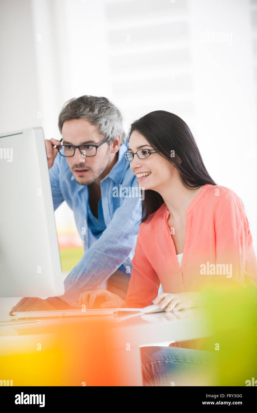 Two colleagues in an office in front of a computer Stock Photo - Alamy