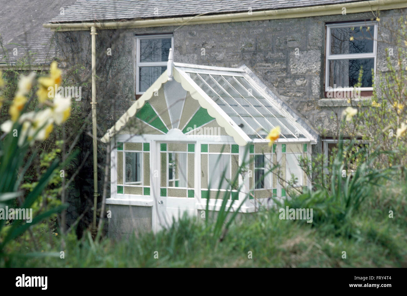 Exterior of a stone cottage with a Victorian glass porch Stock Photo ...