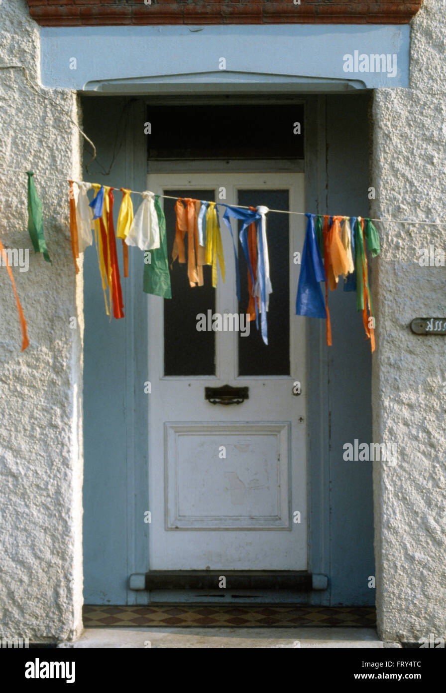Colorful bunting across white front door of a cottage Stock Photo - Alamy