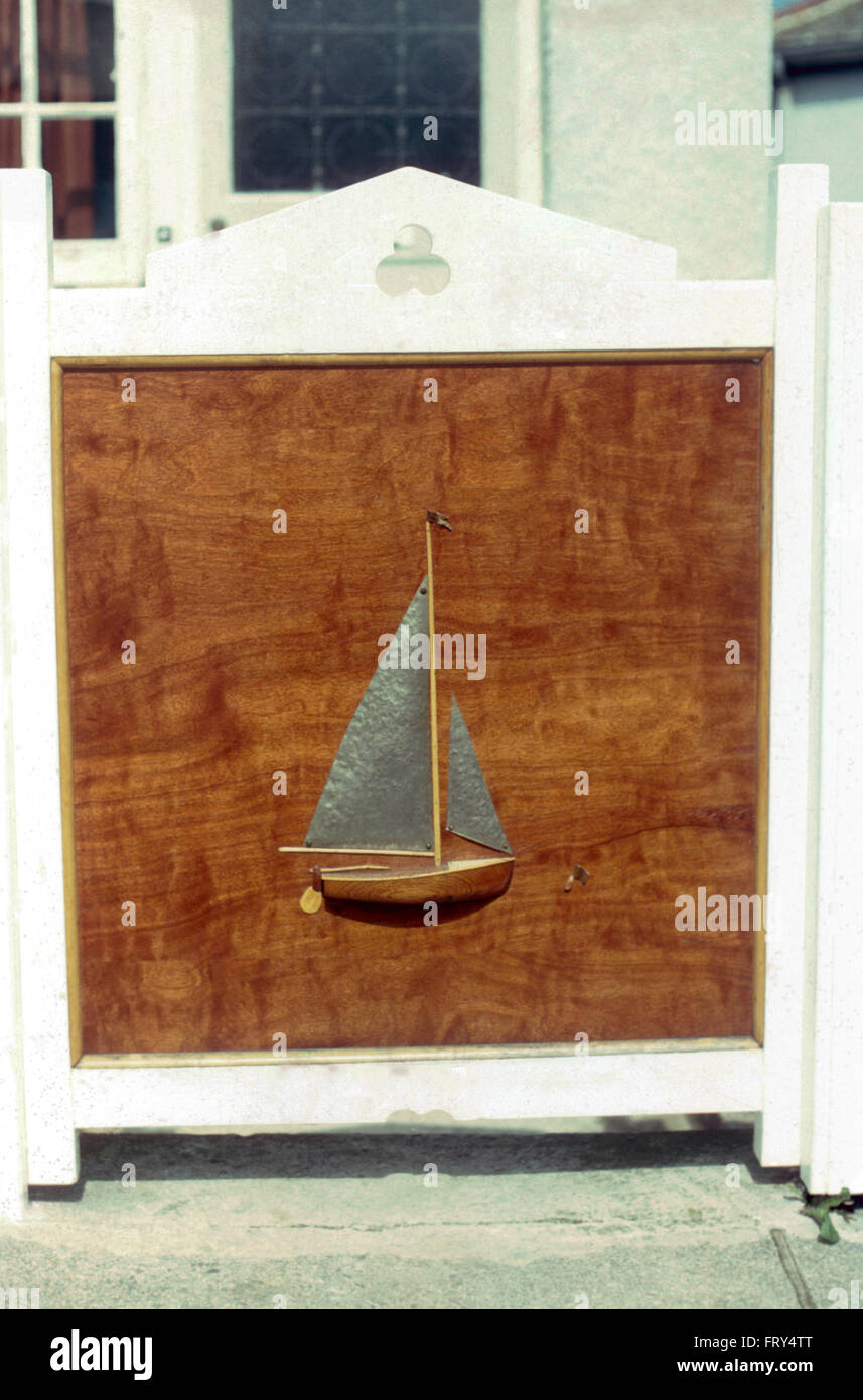 Close-up of nautical themed gate with a model boat attached Stock Photo ...