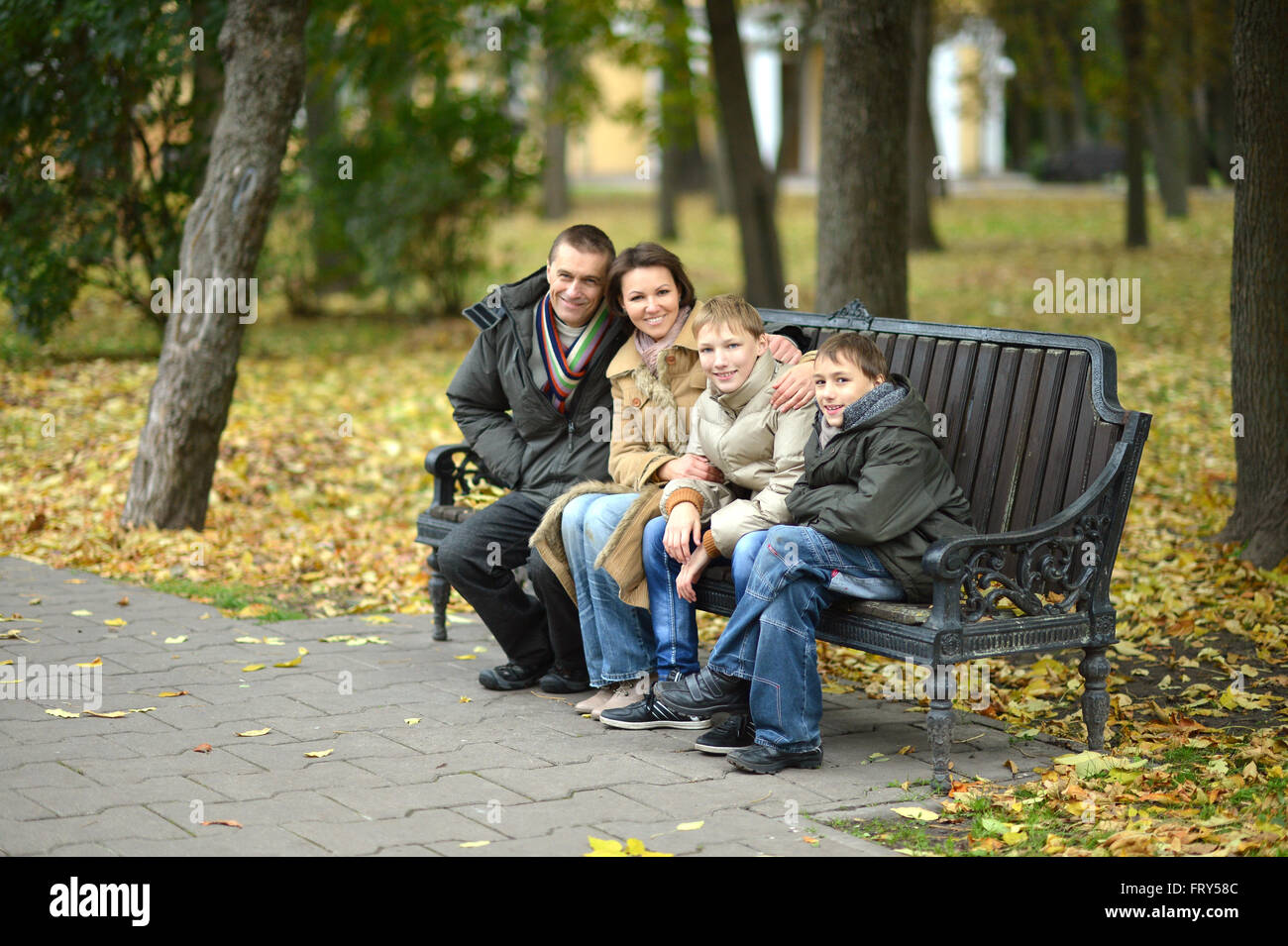 Family of four sitting Stock Photo - Alamy
