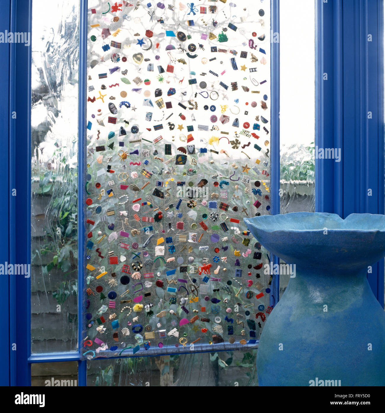 Close-up of glass door with panel of colorful plastic objects Stock ...