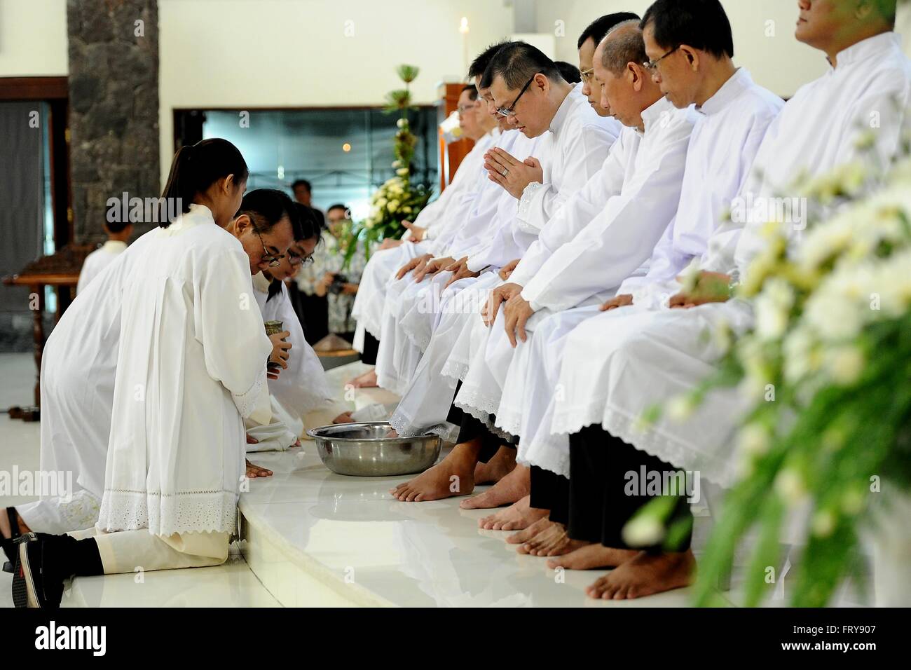 Surabaya, Indonesia. 24th Mar, 2016. Indonesian Catholic devotees hold ...