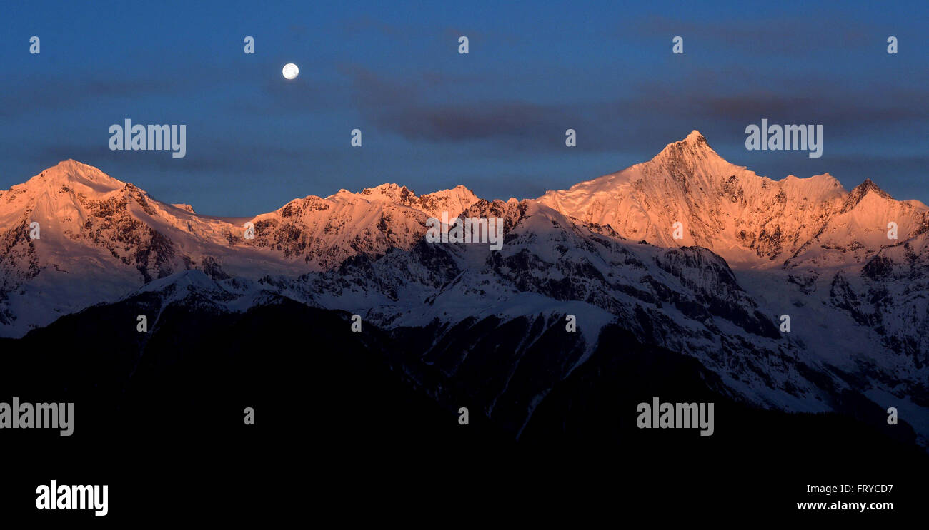Deqen, China's Yunnan Province. 25th Mar, 2016. The moon hangs in the ...