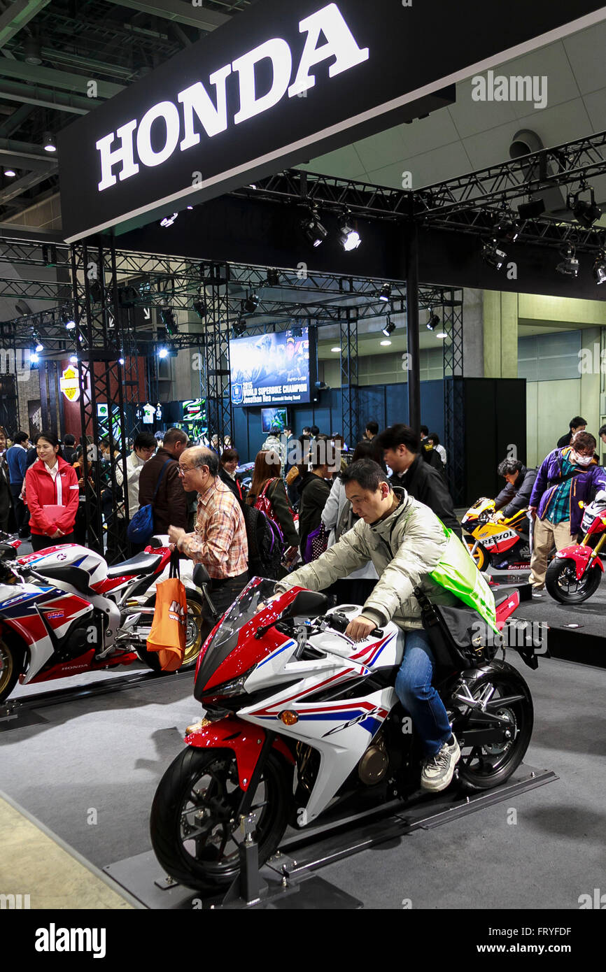 Tokyo, Japan. 25th March, 2016. Visitors sit on Honda motorbikes on ...