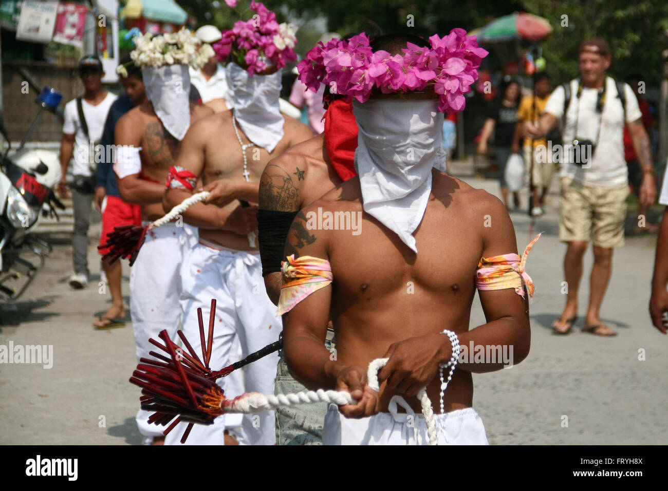 Philippines. 25th Mar, 2016. Penitents walk along the streets of San ...