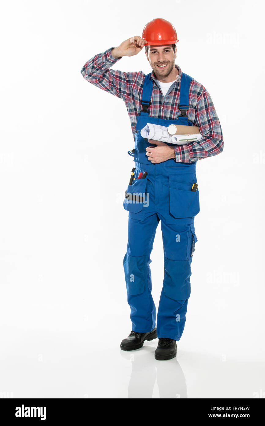 a craftsman in workwear clothing with an hardhat and blueprints in arm ...