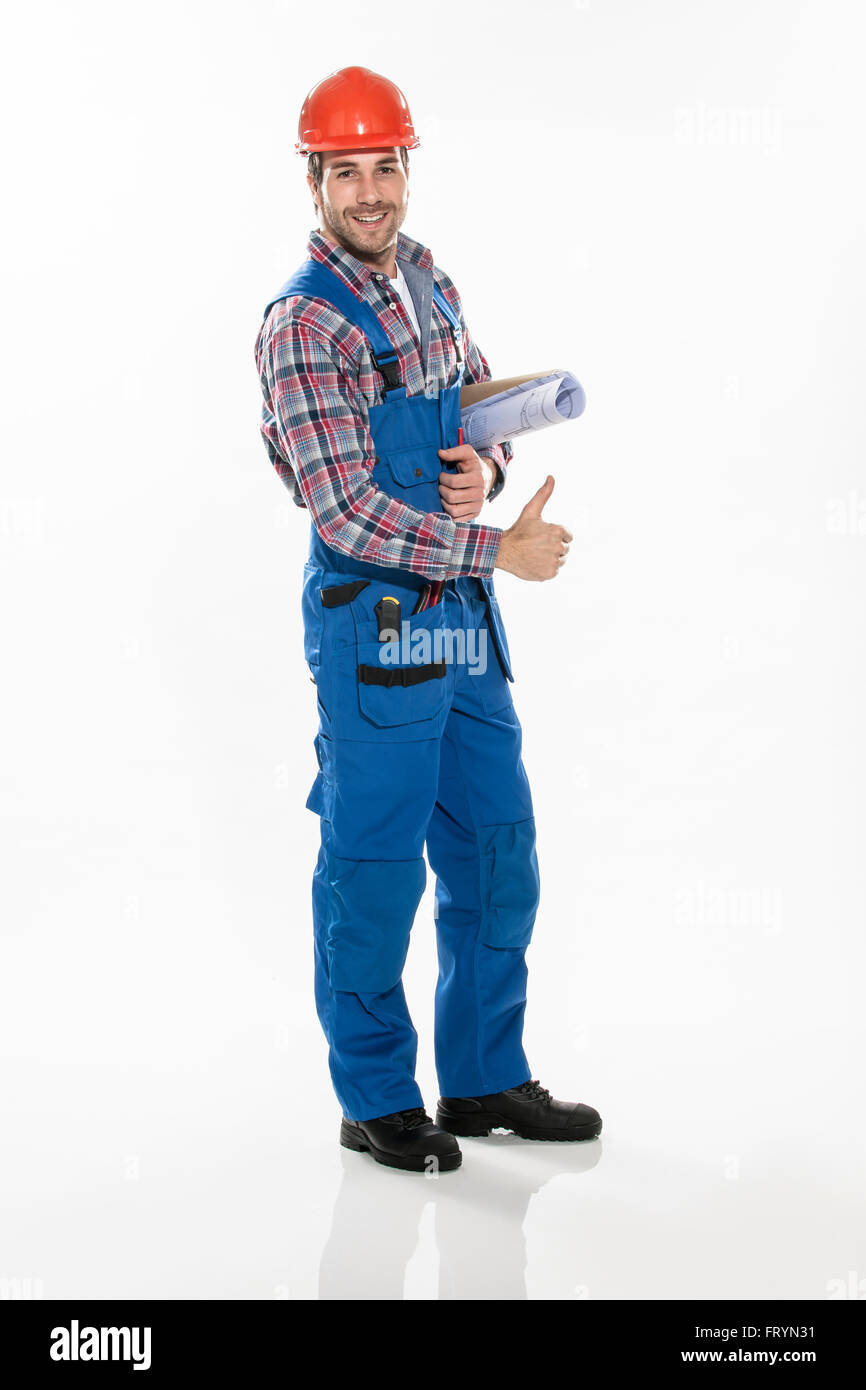 a craftsman in workwear clothing with an hardhat and blueprints in arm ...