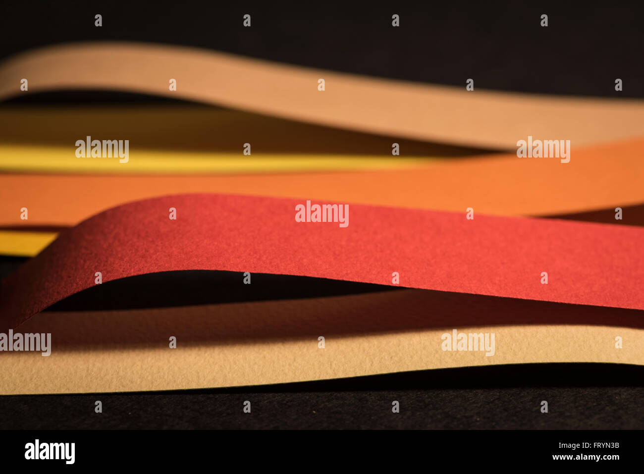 Colourful strips of cardboard as texture and background on black ...