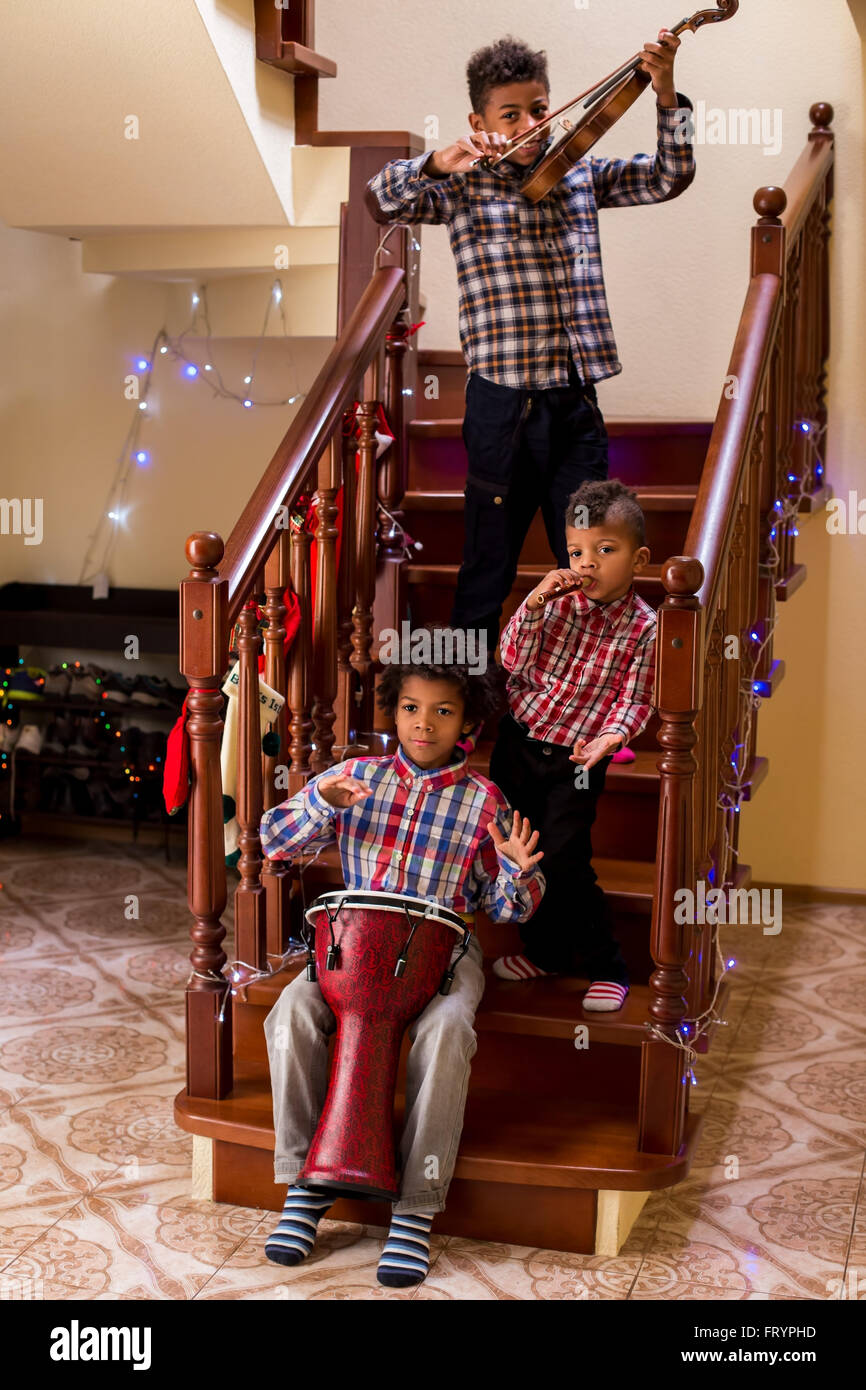 Afro children play three instruments. Three kids playing Christmas ...