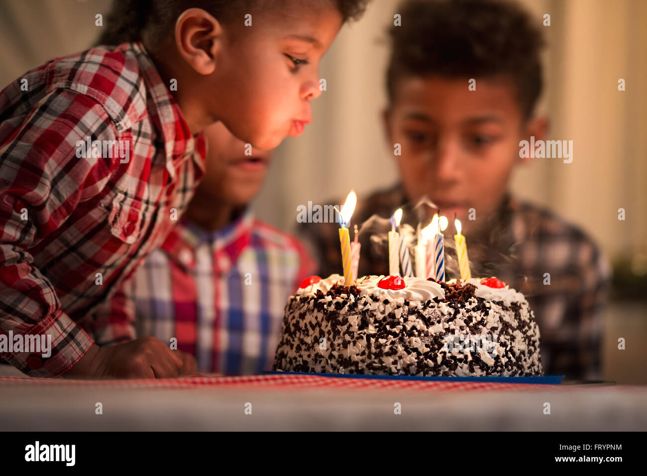 Black toddler blowing candles out. Child blows birthday candles out ...