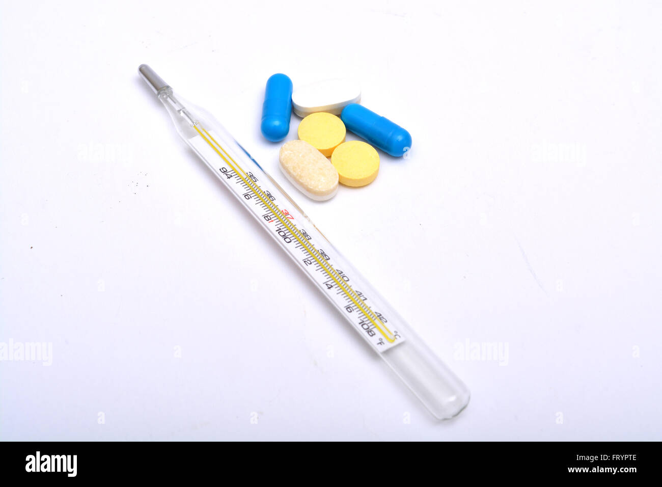 Medicine with thermometer isolated on white background Stock Photo - Alamy