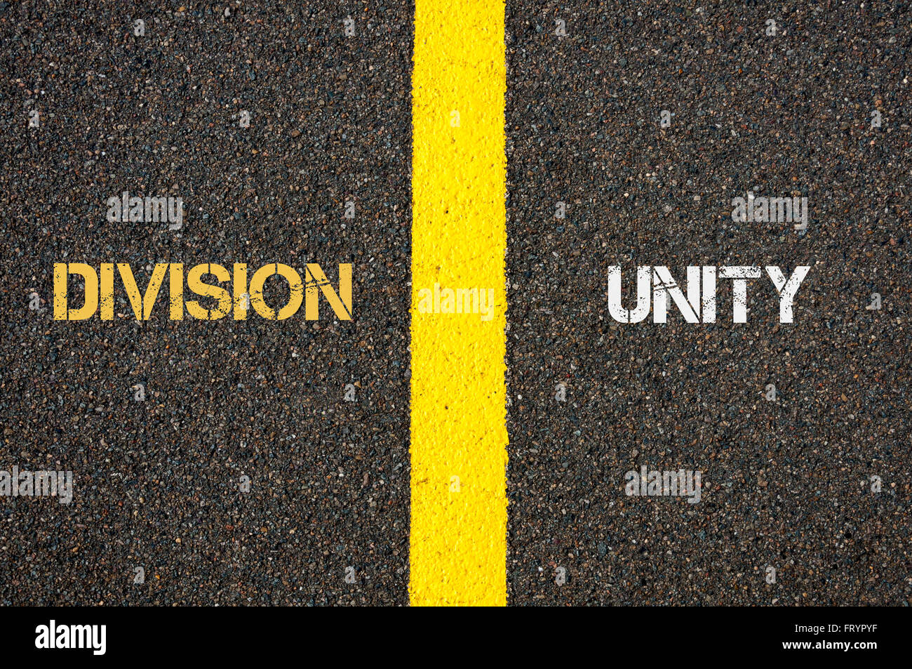 Antonym concept of DIVISION versus UNITY written over tarmac, road ...