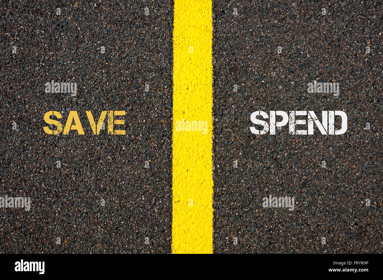 Antonym concept of SAVE versus SPEND written over tarmac, road marking ...