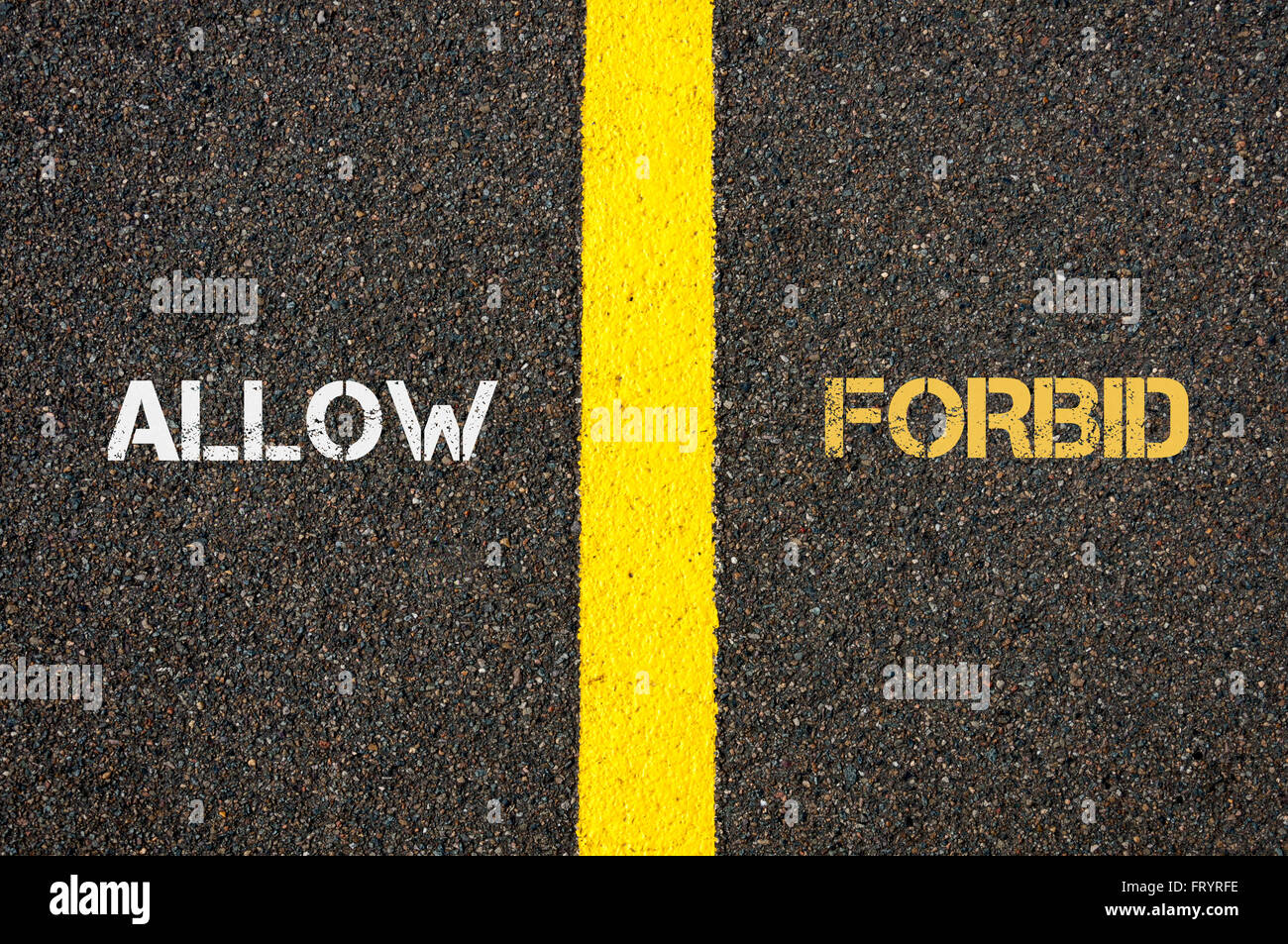 Antonym concept of ALLOW versus FORBID written over tarmac, road ...