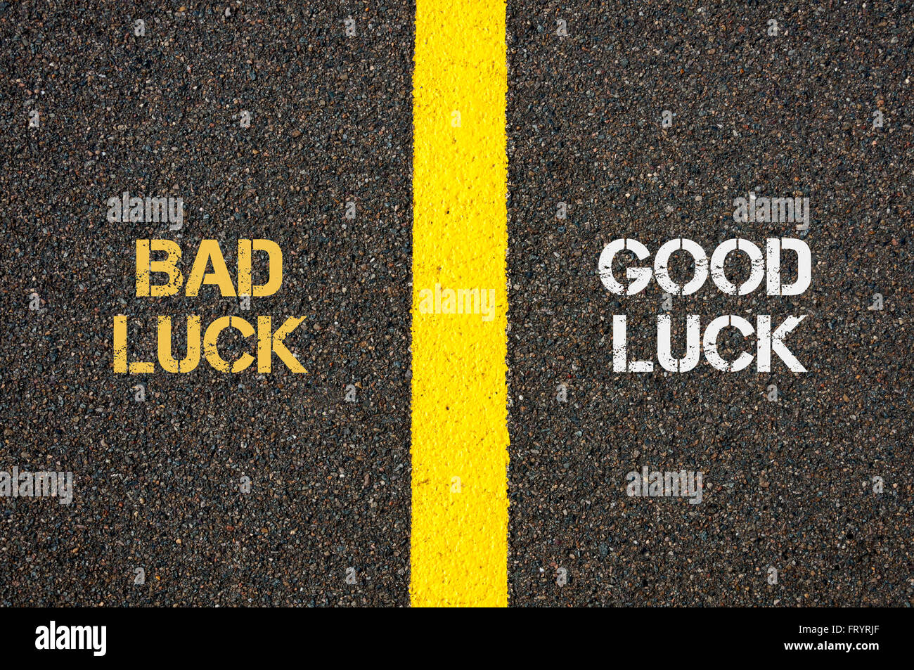Antonym concept of BAD LUCK versus GOOD LUCK written over tarmac, road ...