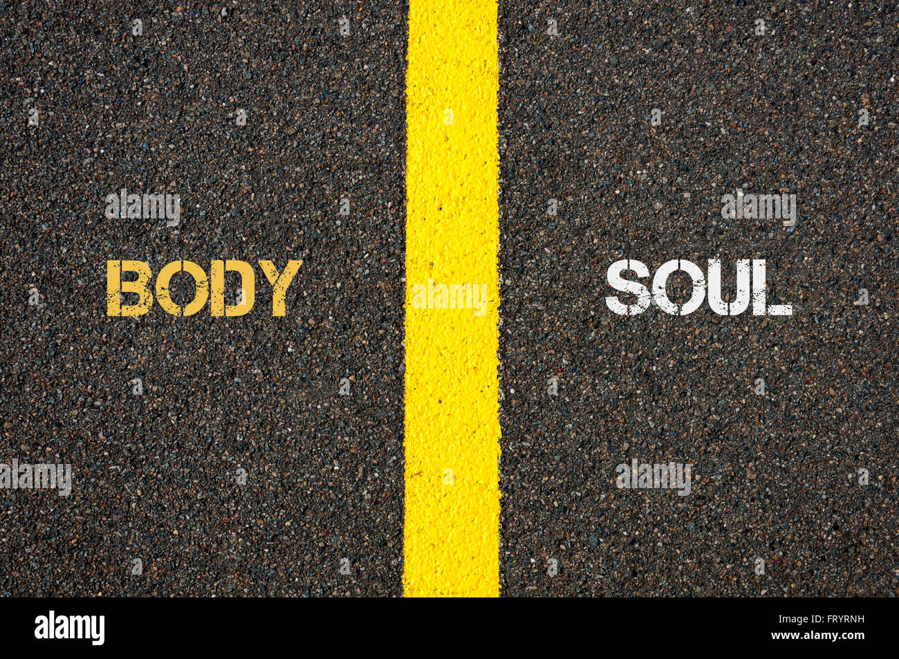 Antonym concept of BODY versus SOUL written over tarmac, road marking ...