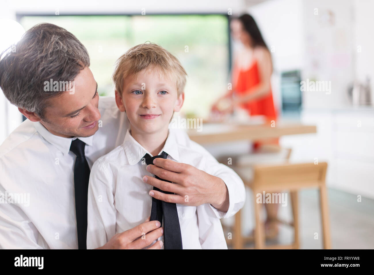 Boy helping father tie tie hi-res stock photography and images - Alamy