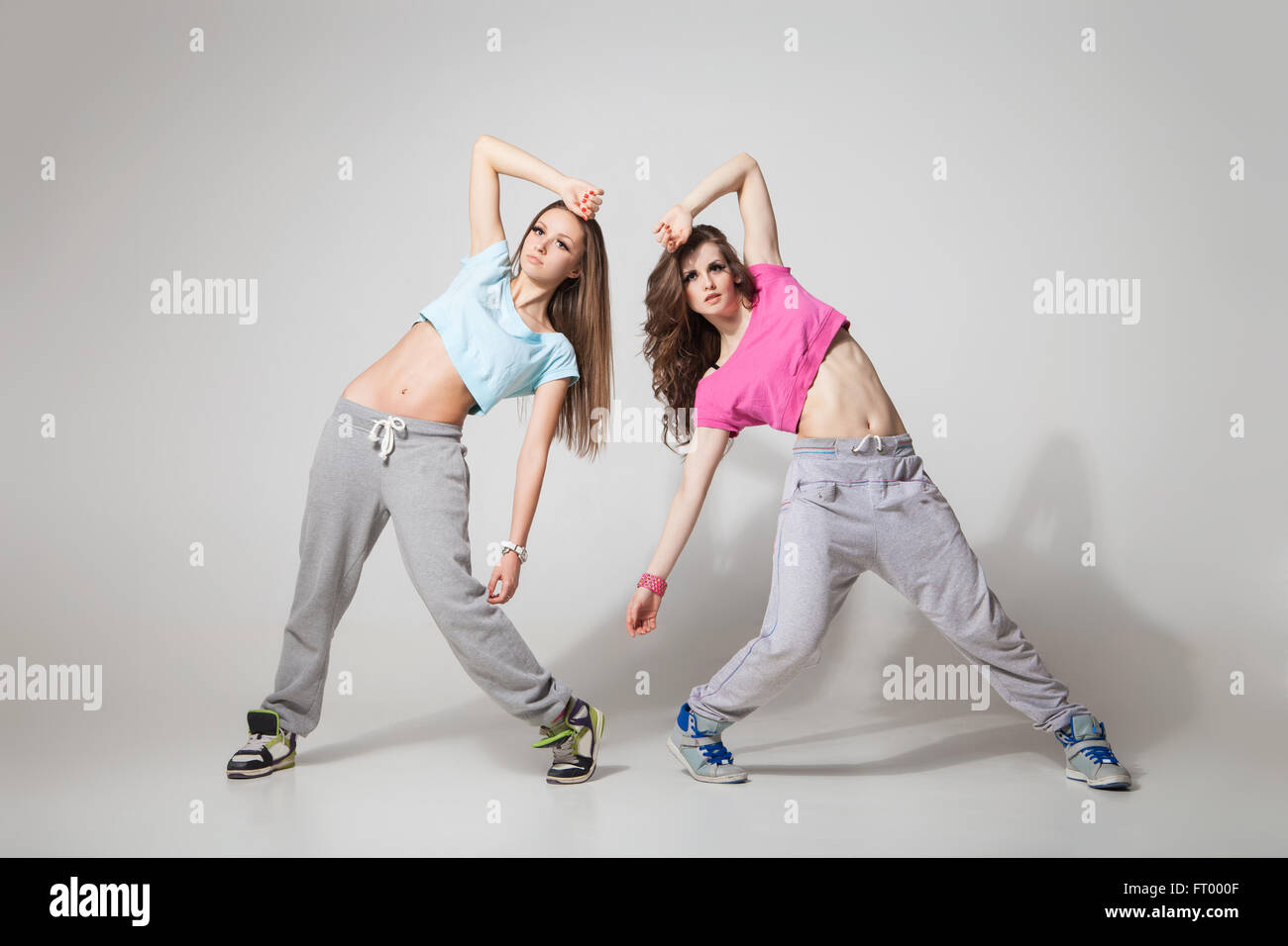 cool looking two dancing women on grey Stock Photo - Alamy