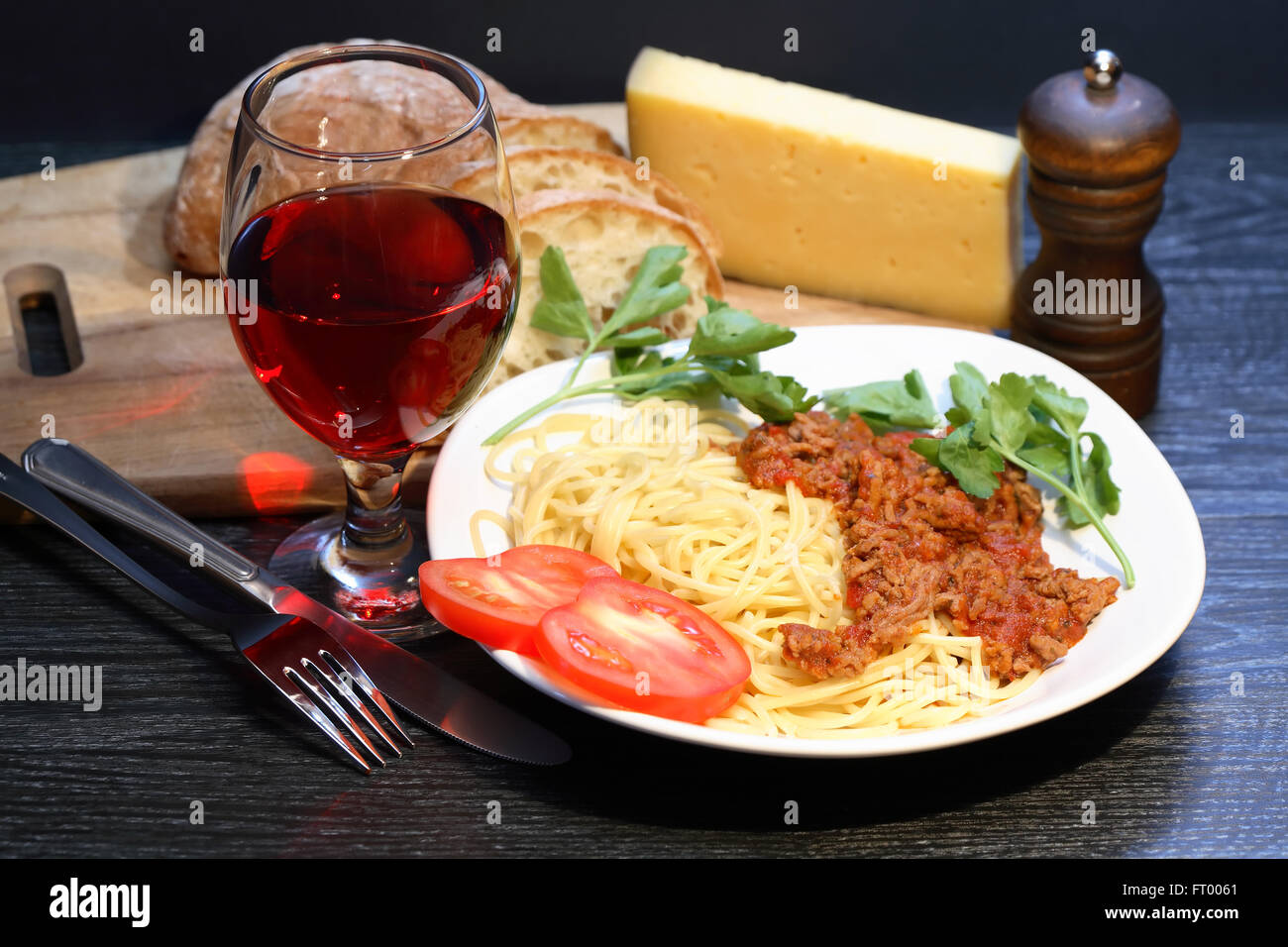 Traditional Italian supper. Plate with Bolognese pasta near red wine ...