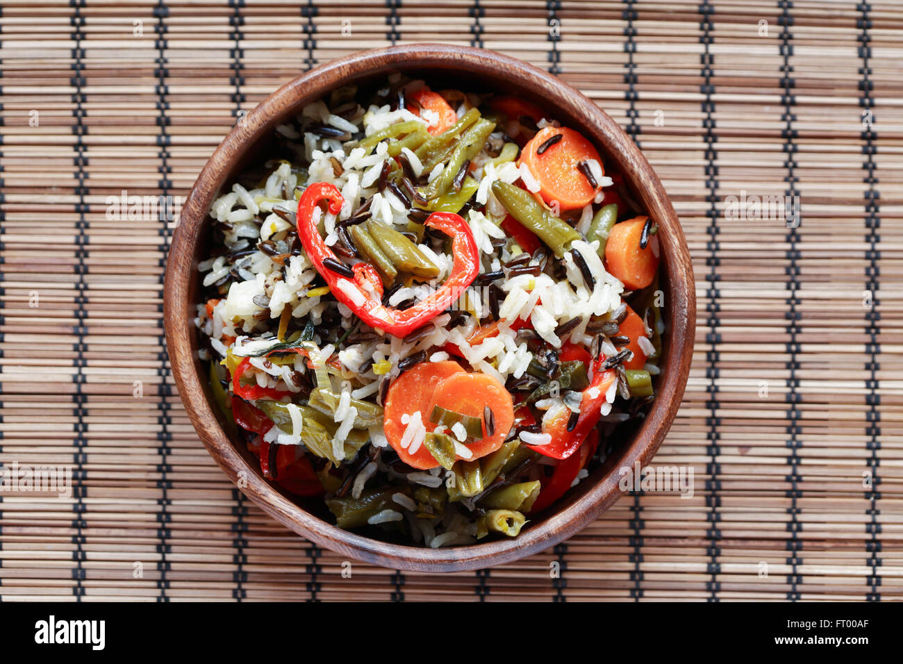 Nice wooden bowl fool of boiled rice with vegetables Stock Photo - Alamy