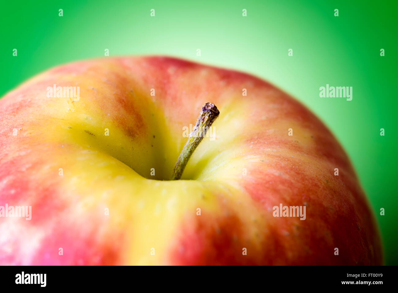 macro apple on green background Stock Photo - Alamy
