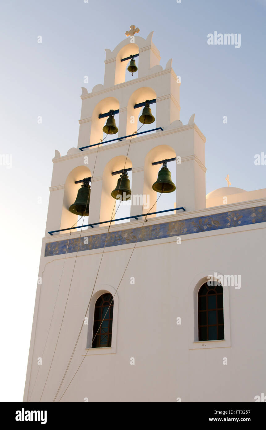 Ropes attached to the bells of a bell tower in front of the light blue ...