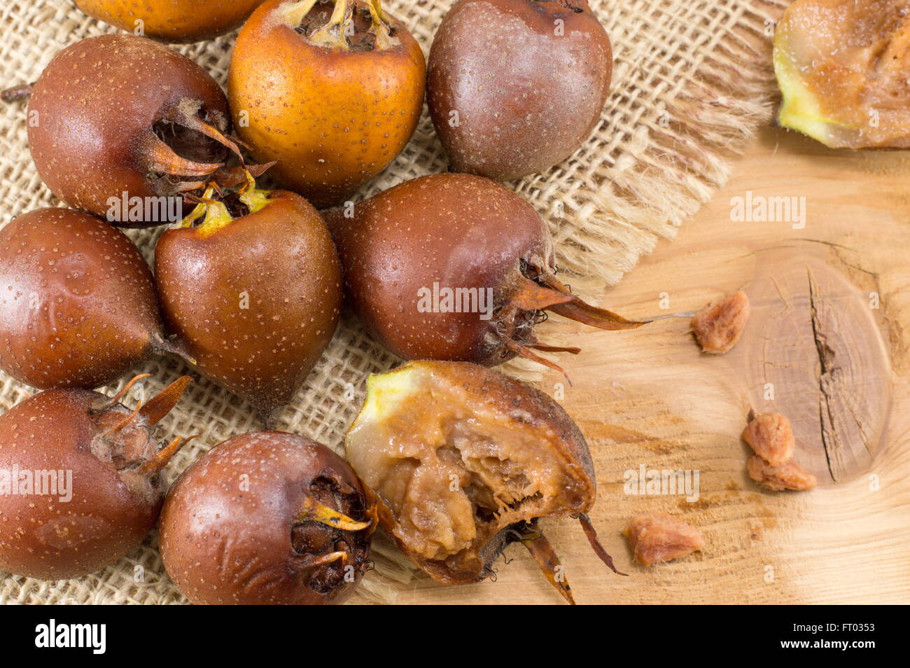 Healthy ripe Medlars on an old wooden table Stock Photo - Alamy