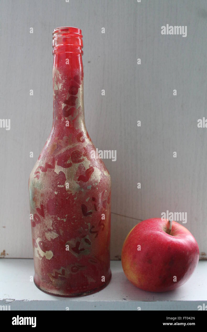 glass fragile bottle under wine painted red and gold color Stock Photo ...