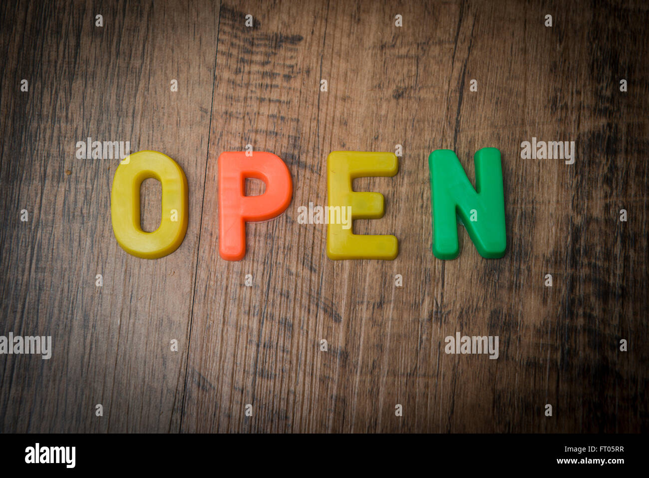 Open, spelt out in multi coloured fridge magnet letters Stock Photo - Alamy