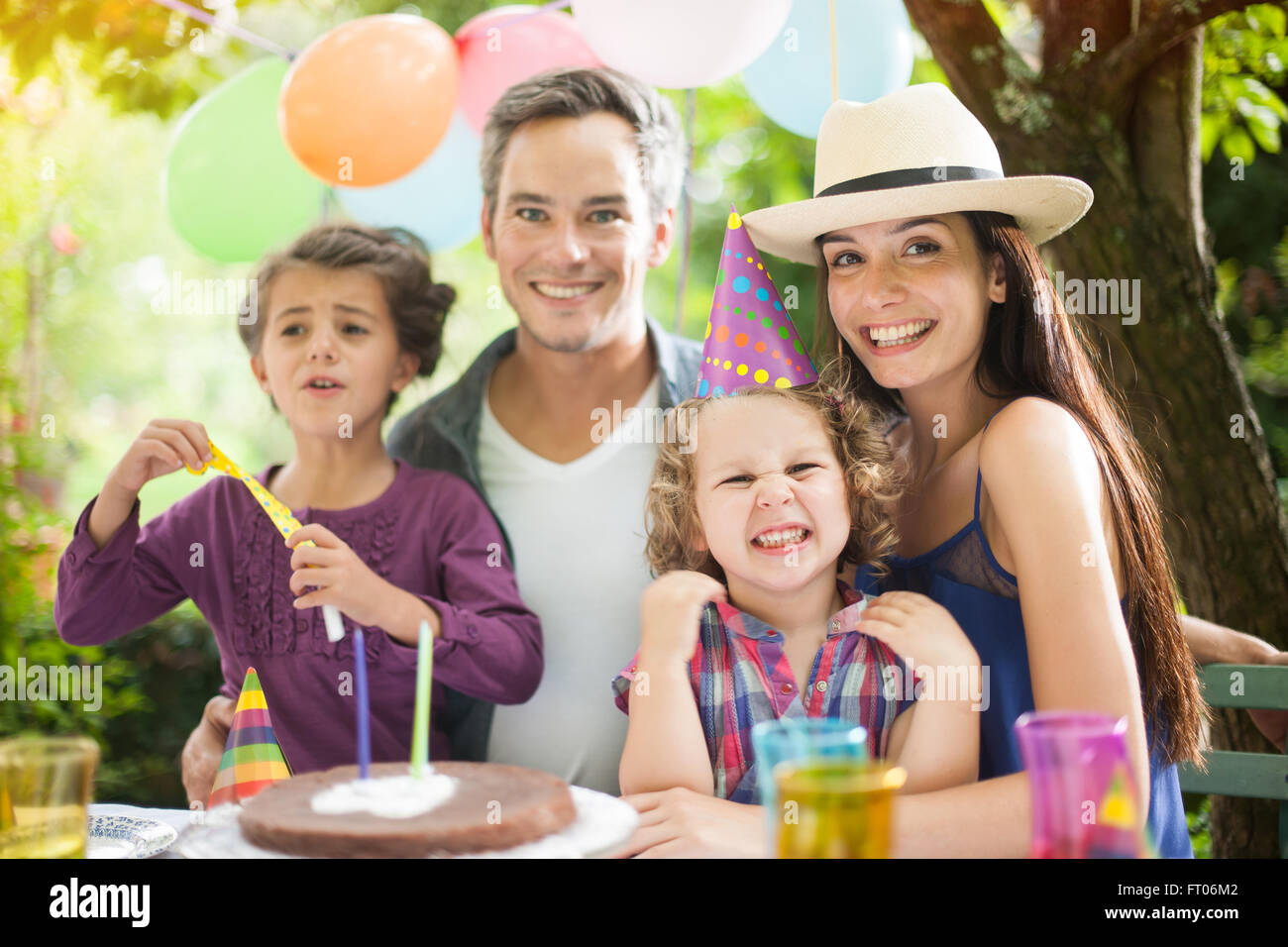 Birthday party in family. Four people family portrait Stock Photo - Alamy