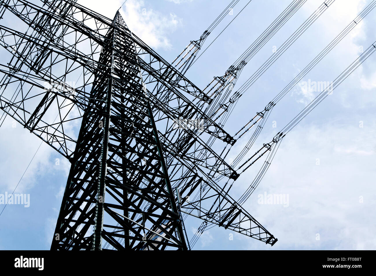 High voltage pylon in blue sky background Stock Photo - Alamy