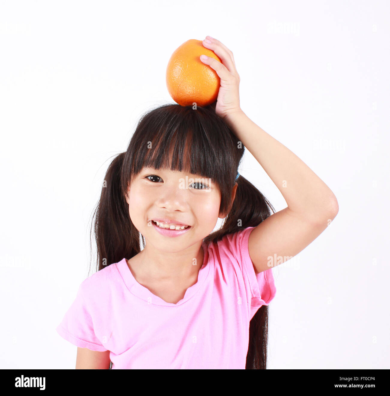 Young girl with orange Stock Photo - Alamy