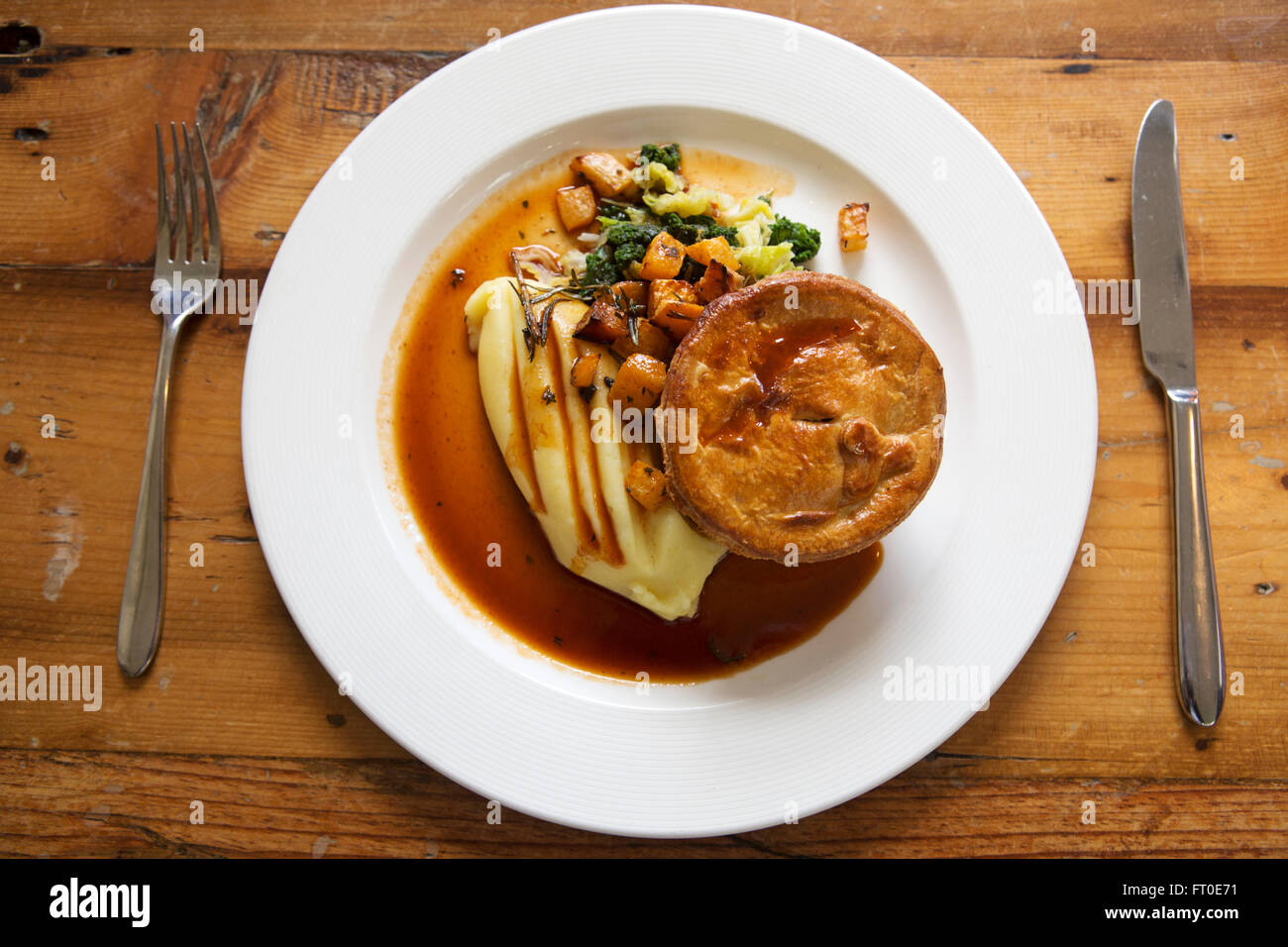 Venison pie served with mashed potatoe and seasonal vegetables in ...