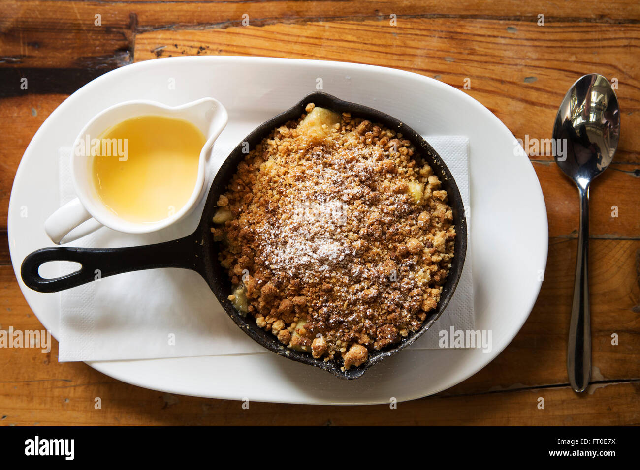 Apple crumble served with a pot of custard in London, England Stock ...