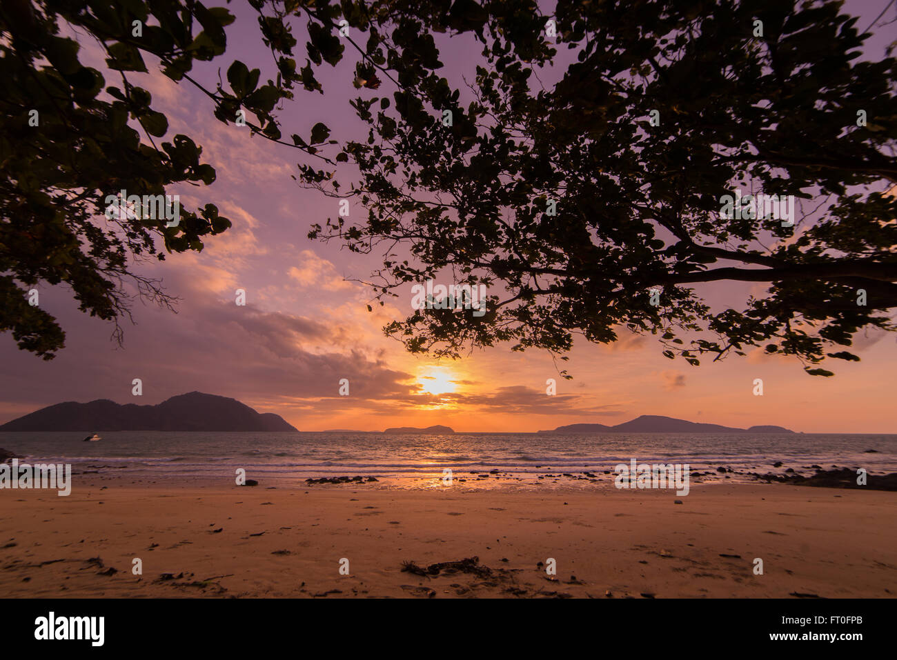 Tropical sunset on the beach in Thailand Stock Photo - Alamy