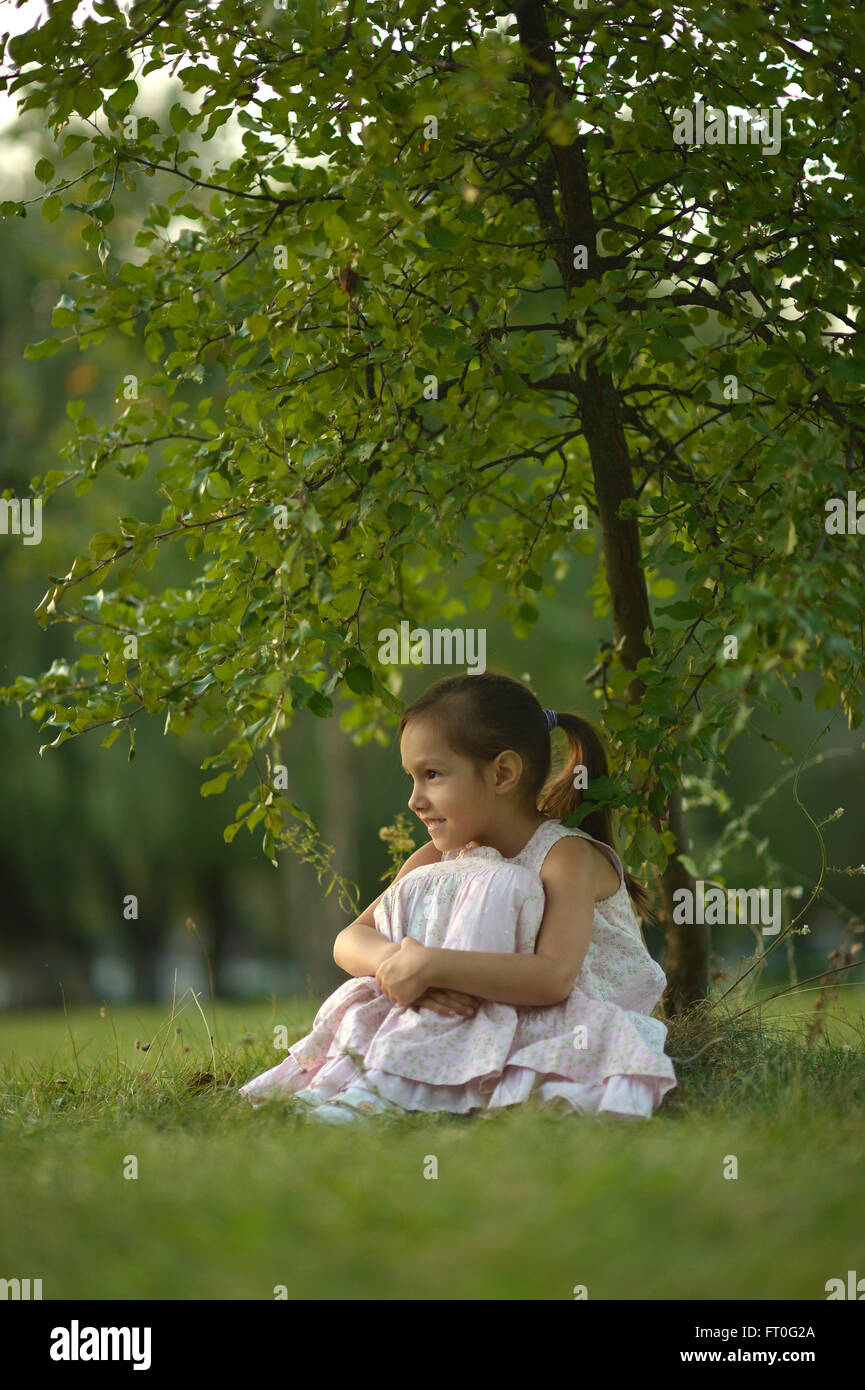 Little girl sitting under Stock Photo - Alamy Little girl sitting under Stock Photo - Alamy