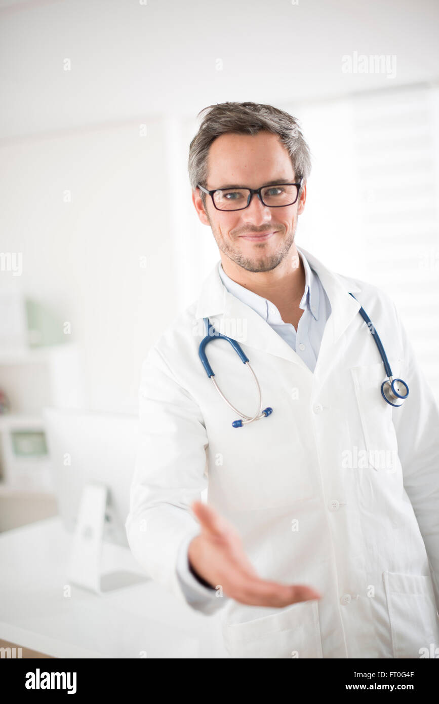 young doctor welcoming at his office Stock Photo - Alamy