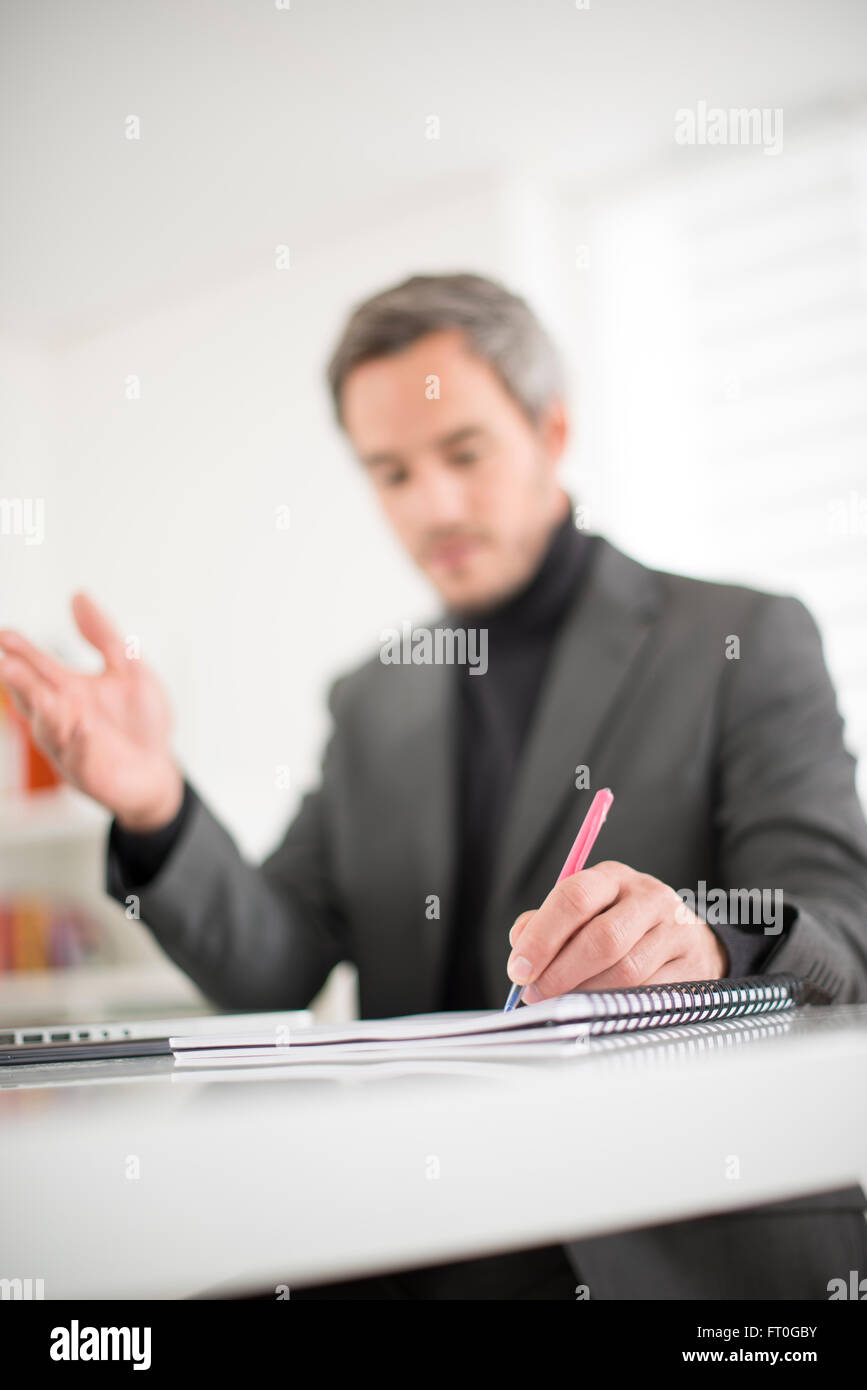 attractive man working in office, focus on his writing hand Stock Photo ...