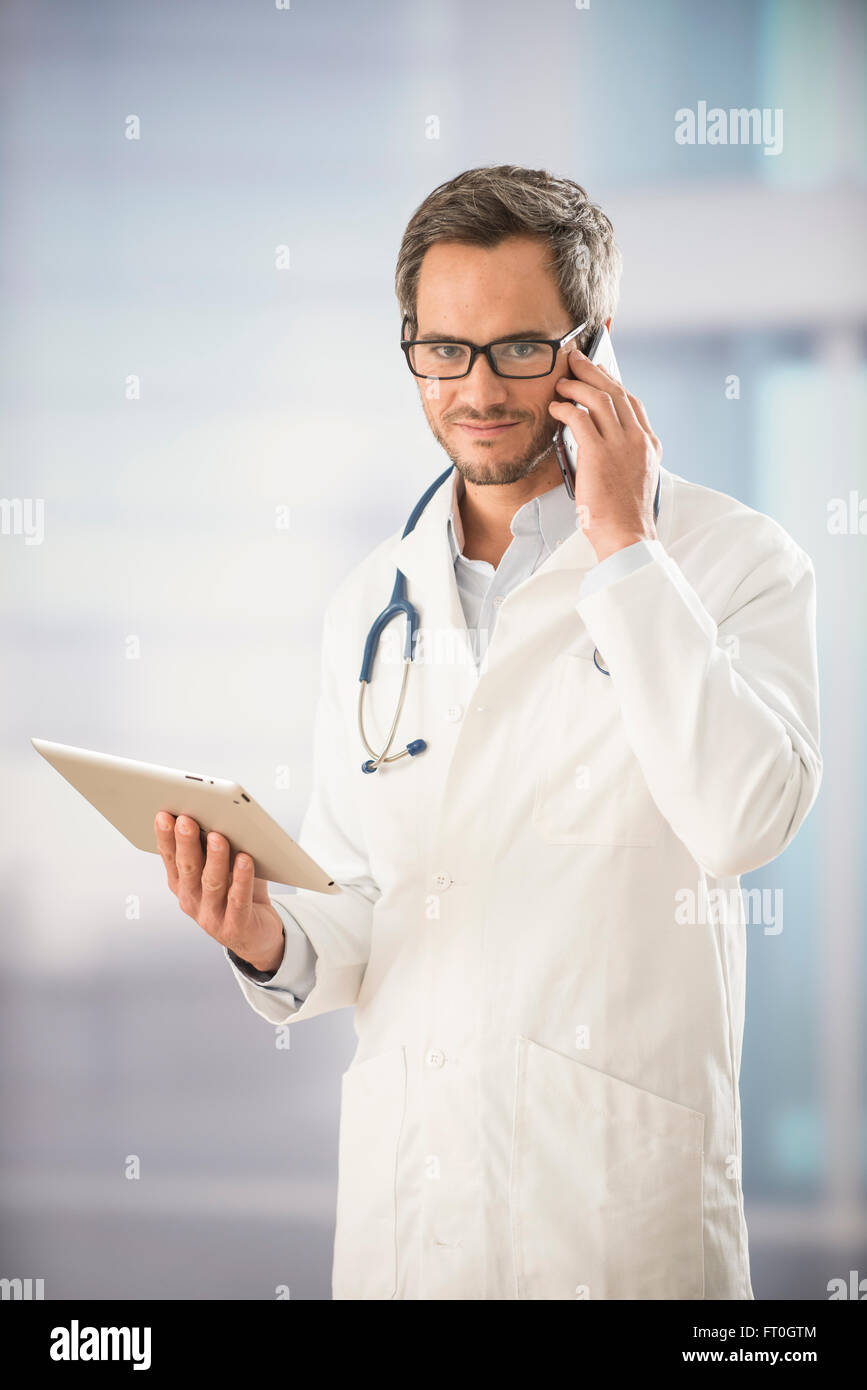 doctor at phone in hospital Stock Photo - Alamy
