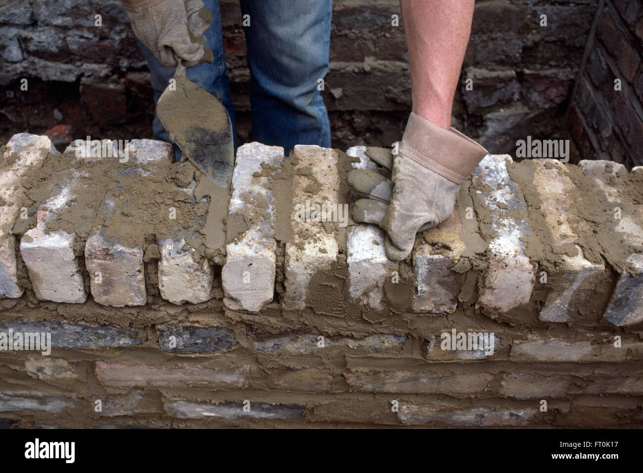Close-up of hands laying a low brick wall Stock Photo - Alamy