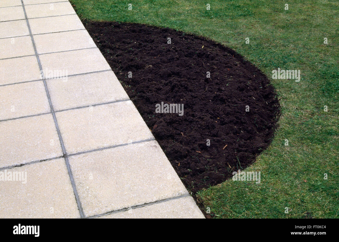 A semi-circular border beside a newly laid paved path Stock Photo - Alamy