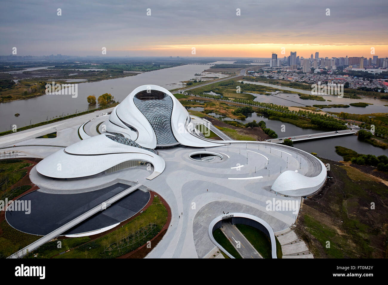 Aerial view of opera house embedded in Harbin's wetland with Songhua ...