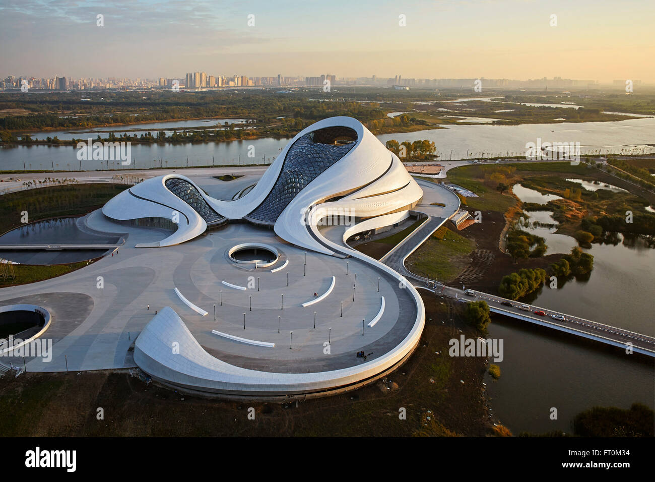 Aerial view of opera house embedded in Harbin's wetland with Songhua ...