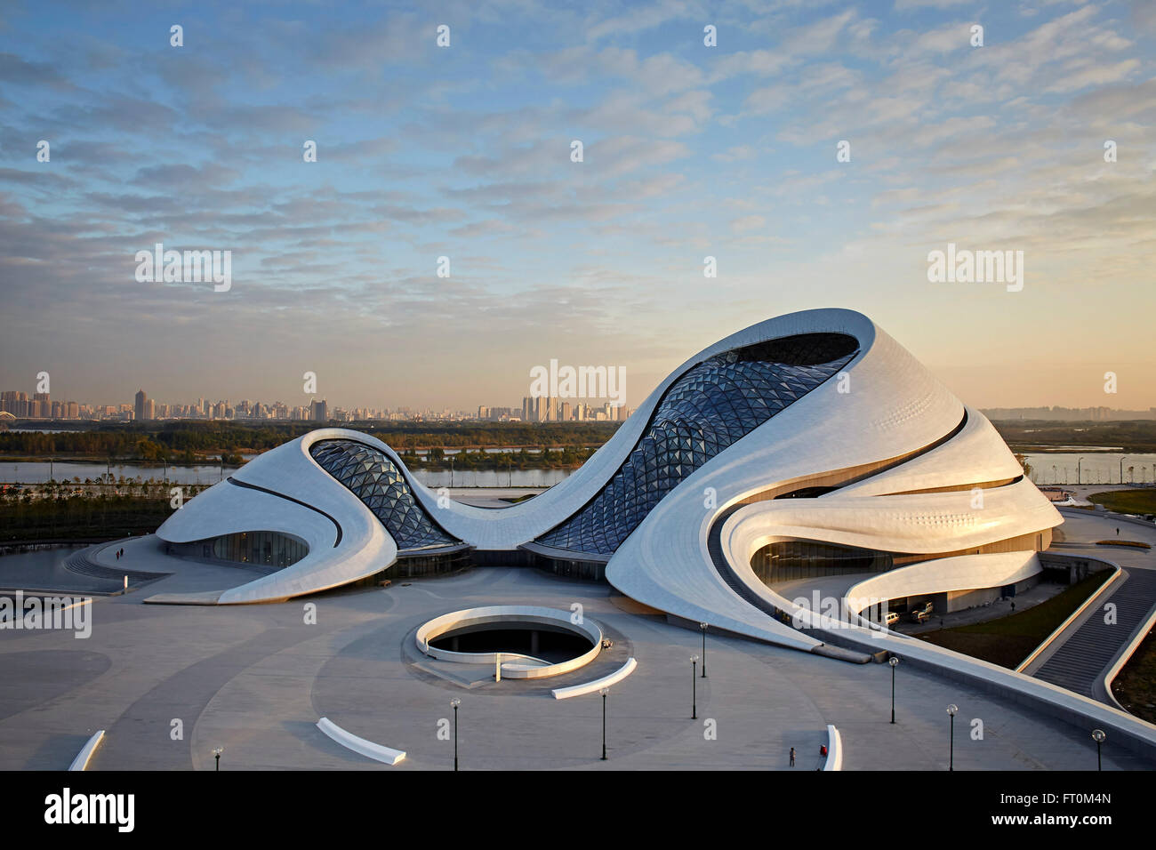 Aerial view of opera house with Harbin's skyline in background. Harbin ...