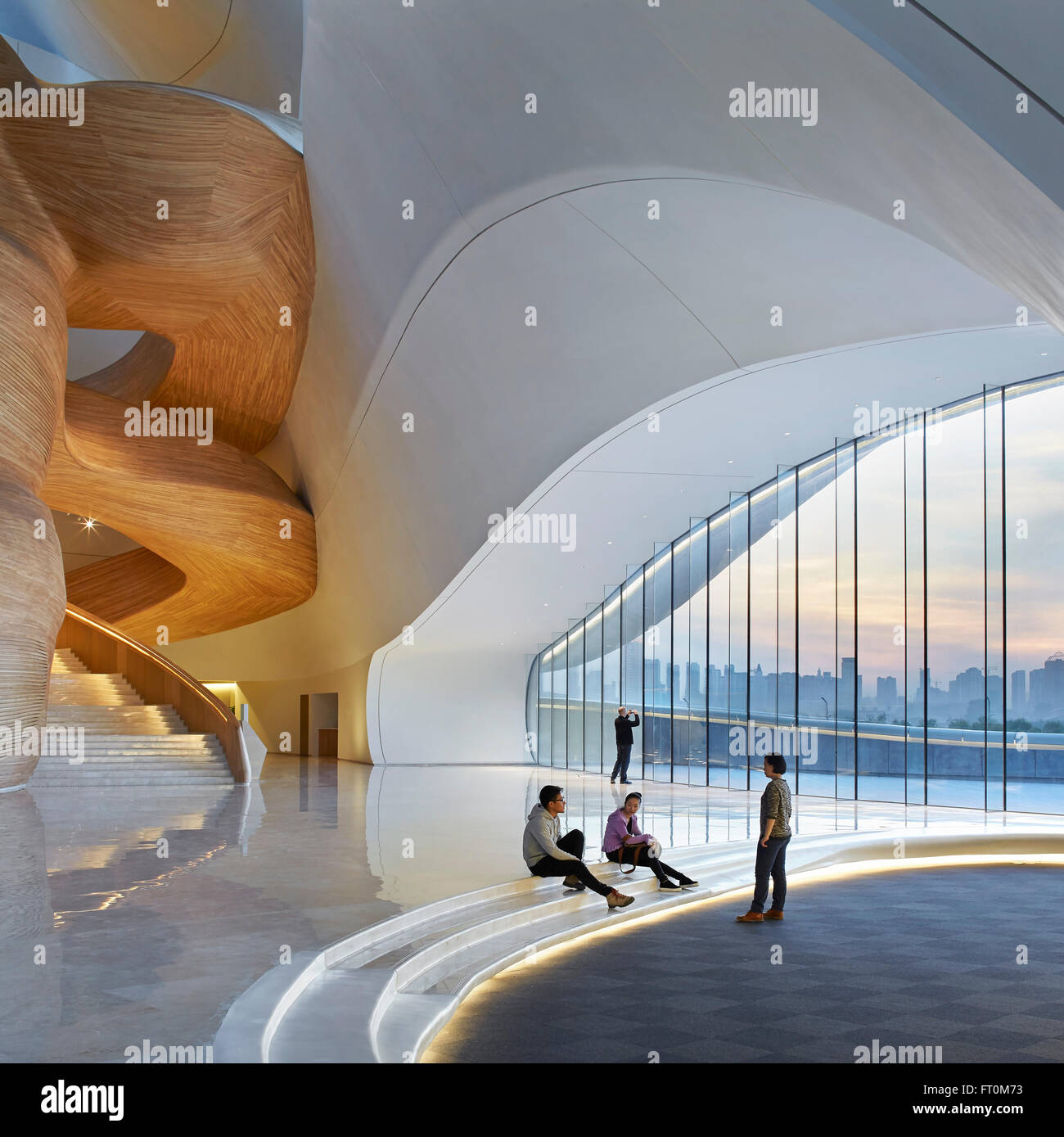 Entrance foyer with panoramic window and timber sculpted stairway ...