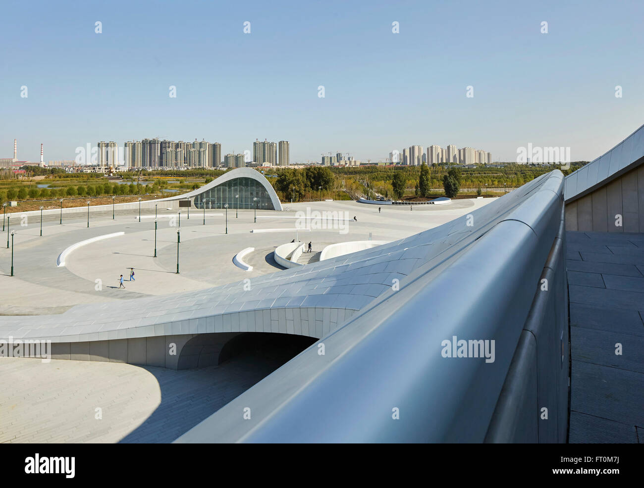 View across opera square with city high-rises beyond. Harbin Opera ...